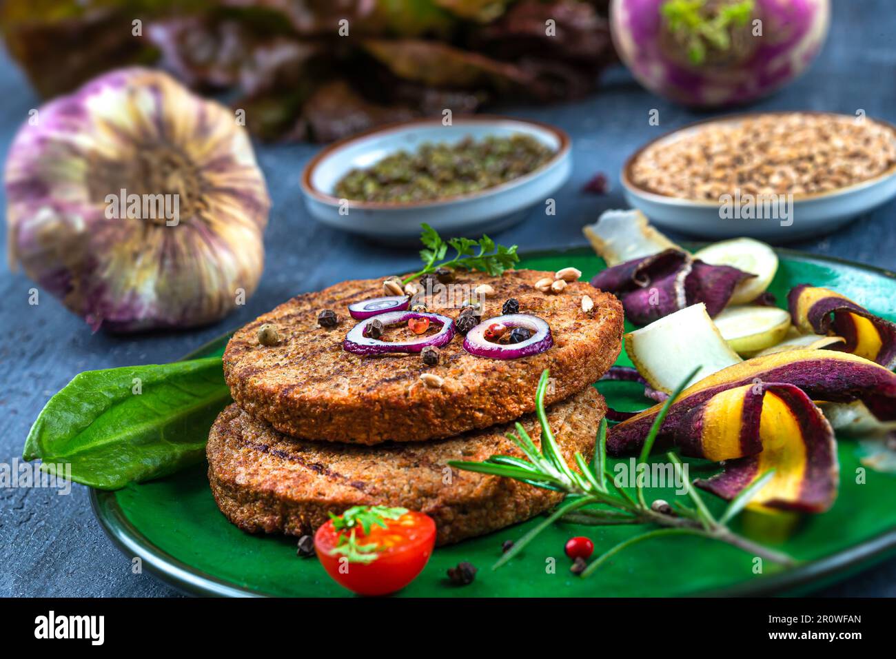 Two veggie burger patties amidst ingredients and vegetable garnishes ...