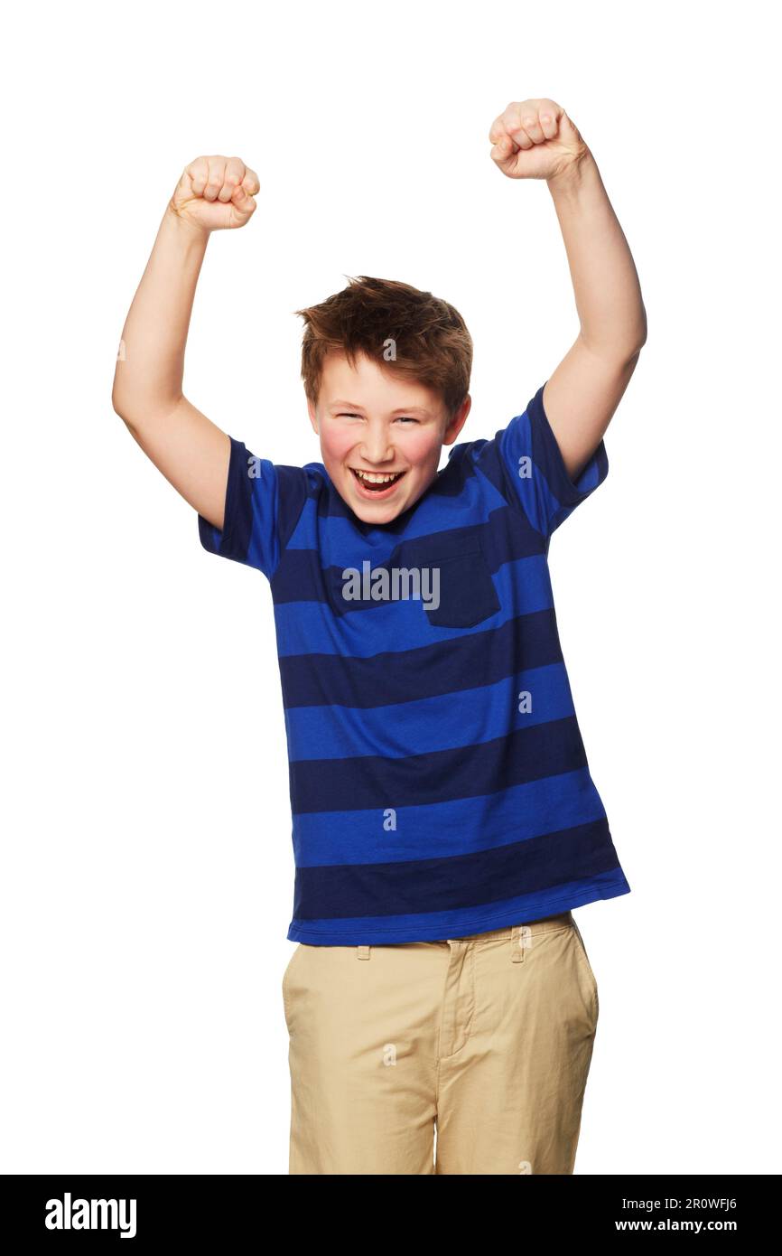 Portrait, celebration and excited kid with hands raised in studio ...