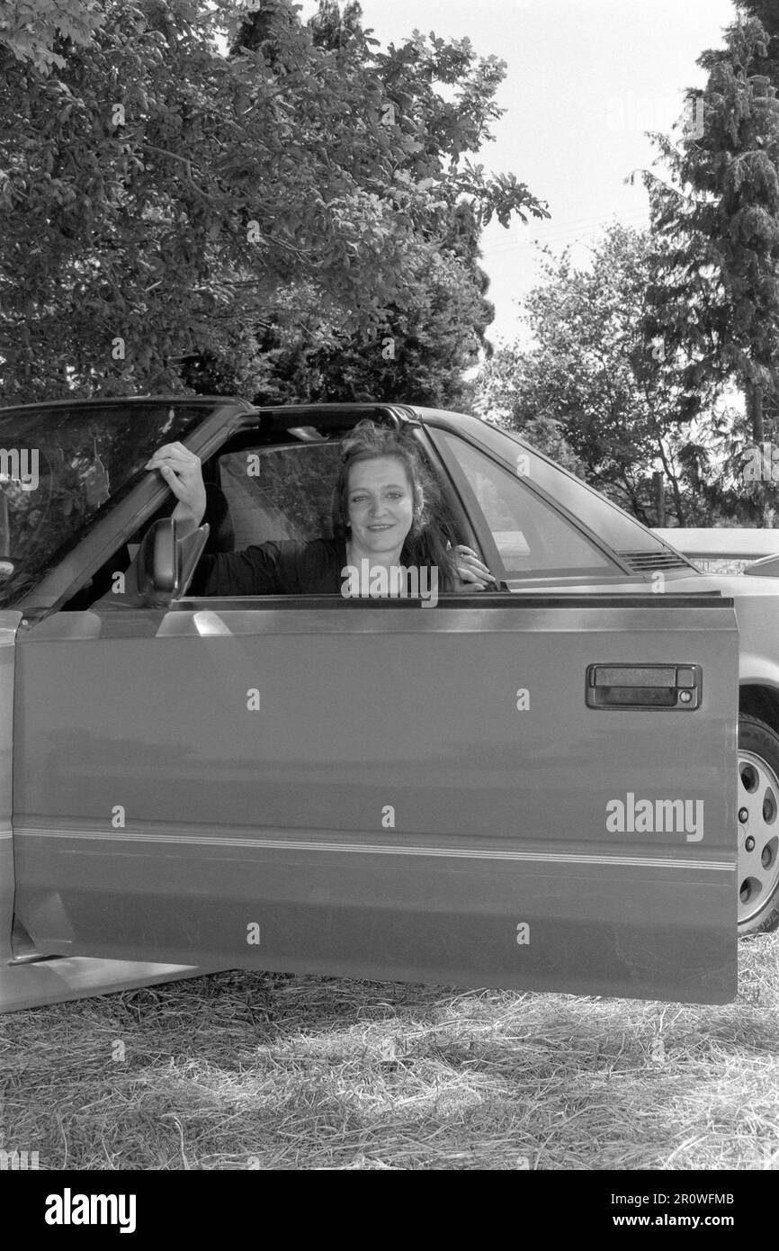 young slim dark haired female posing for portrait with toyoya mr2 mk1 t ...