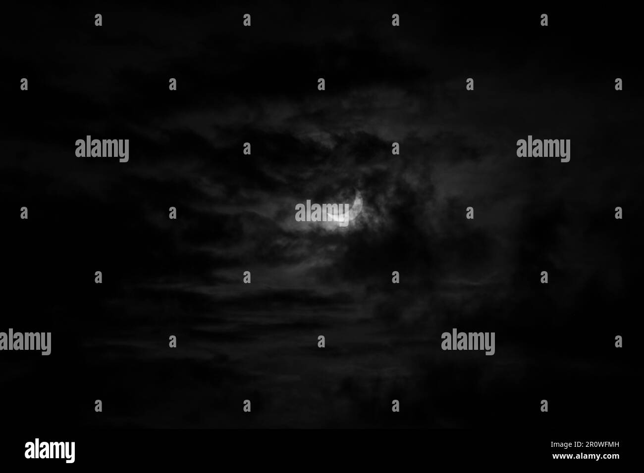 A narrow semicircle of the moon in cloudy cloudy weather. Sickle ...