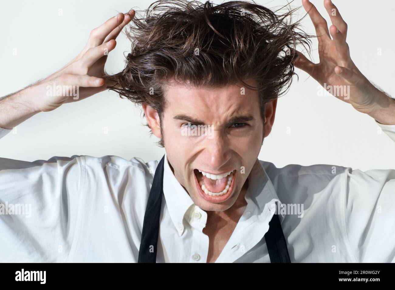 Crazy, scream and portrait of business man on white background with ...