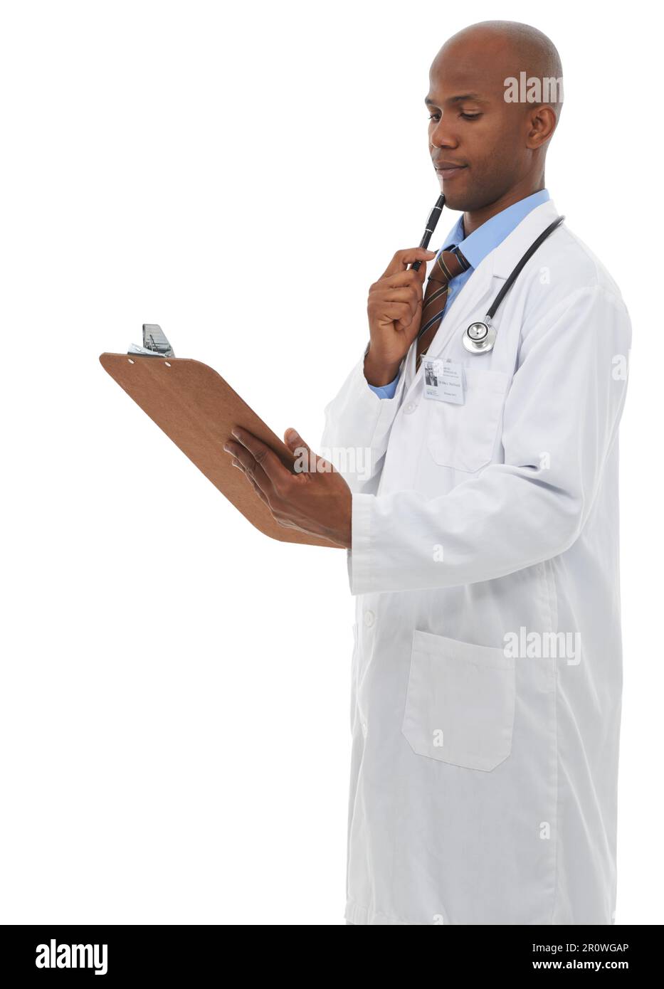 Pondering over your medical chart. A young doctor looking pensively at ...