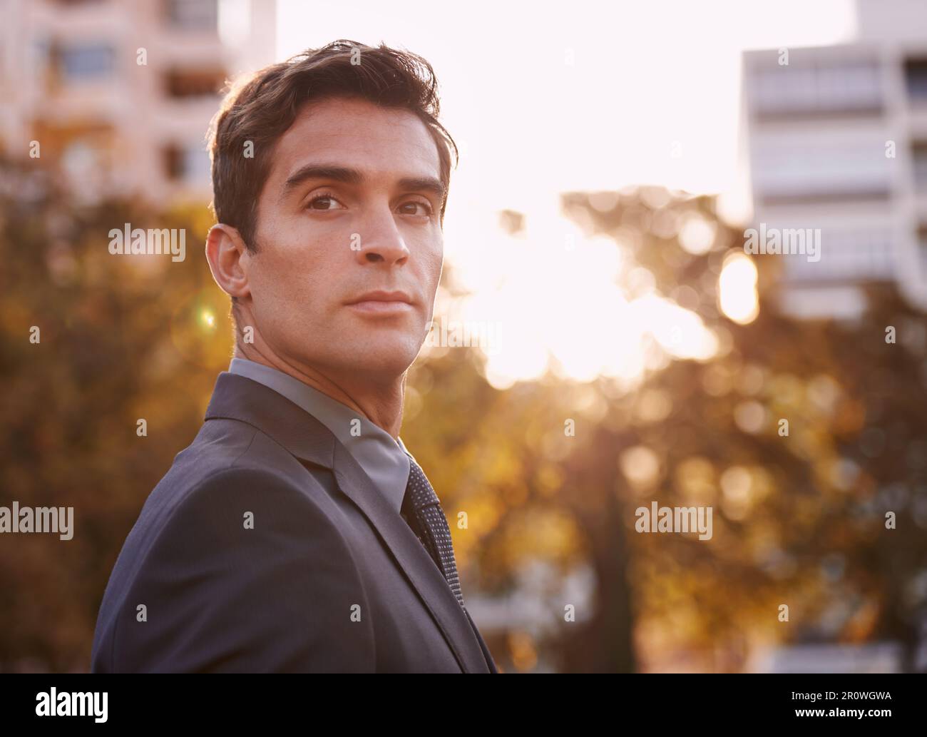 Businessman outside office buildings contemplating hi-res stock ...