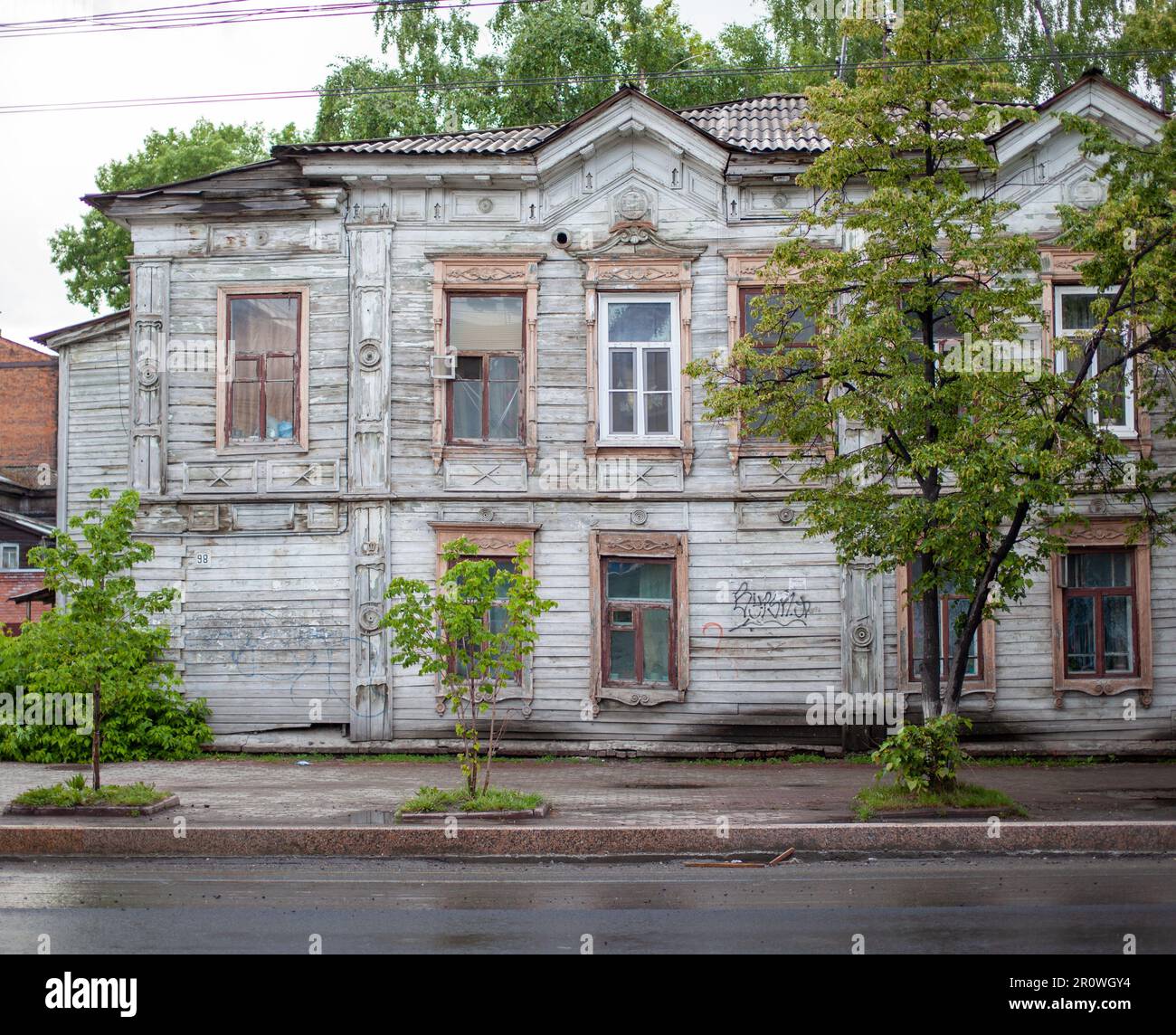 Old wooden two-storey houses with windows in the city of Tomsk, Russia ...