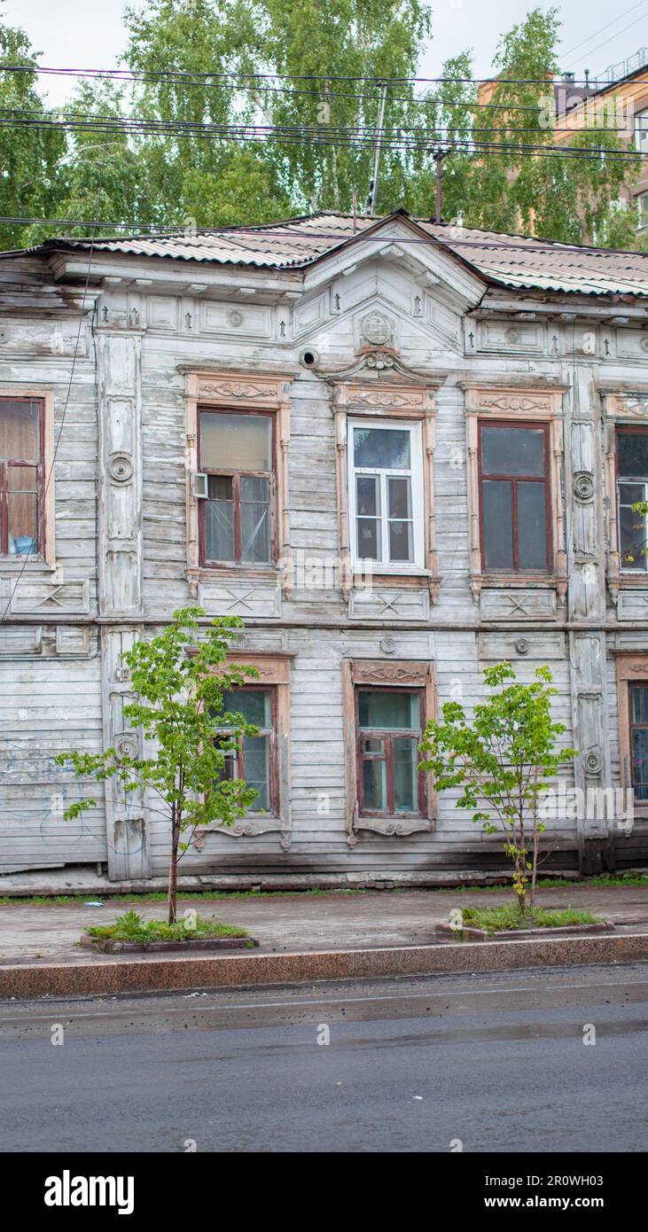Old wooden two-storey houses with windows in the city of Tomsk, Russia ...