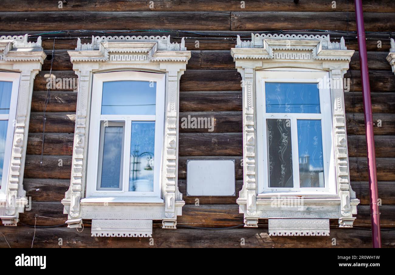 Old wooden two-storey houses with windows in the city of Tomsk, Russia ...