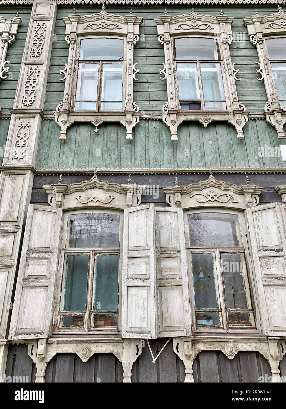 Old wooden two-storey houses with windows in the city of Tomsk, Russia ...