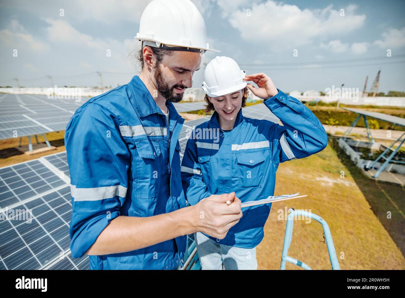 Solar engineers visually examine panel arrays on farm sites using ...