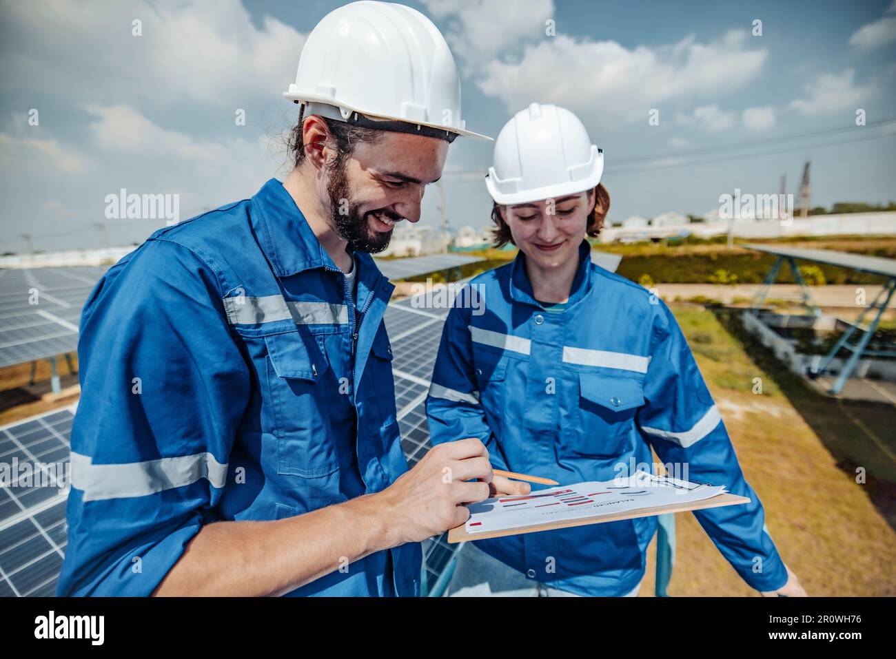 Solar engineers visually examine panel arrays on farm sites using ...