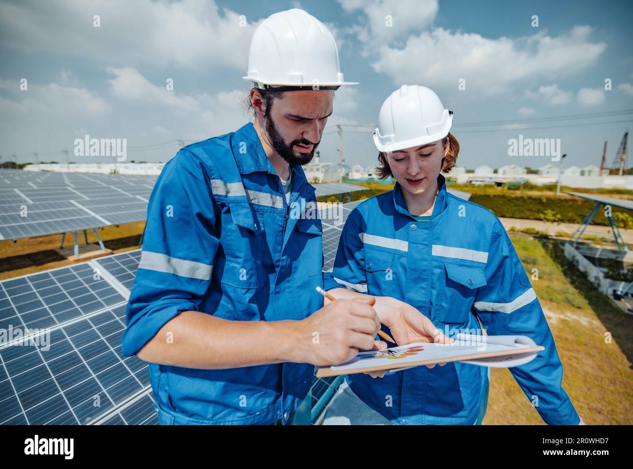 Solar engineers visually examine panel arrays on farm sites using ...