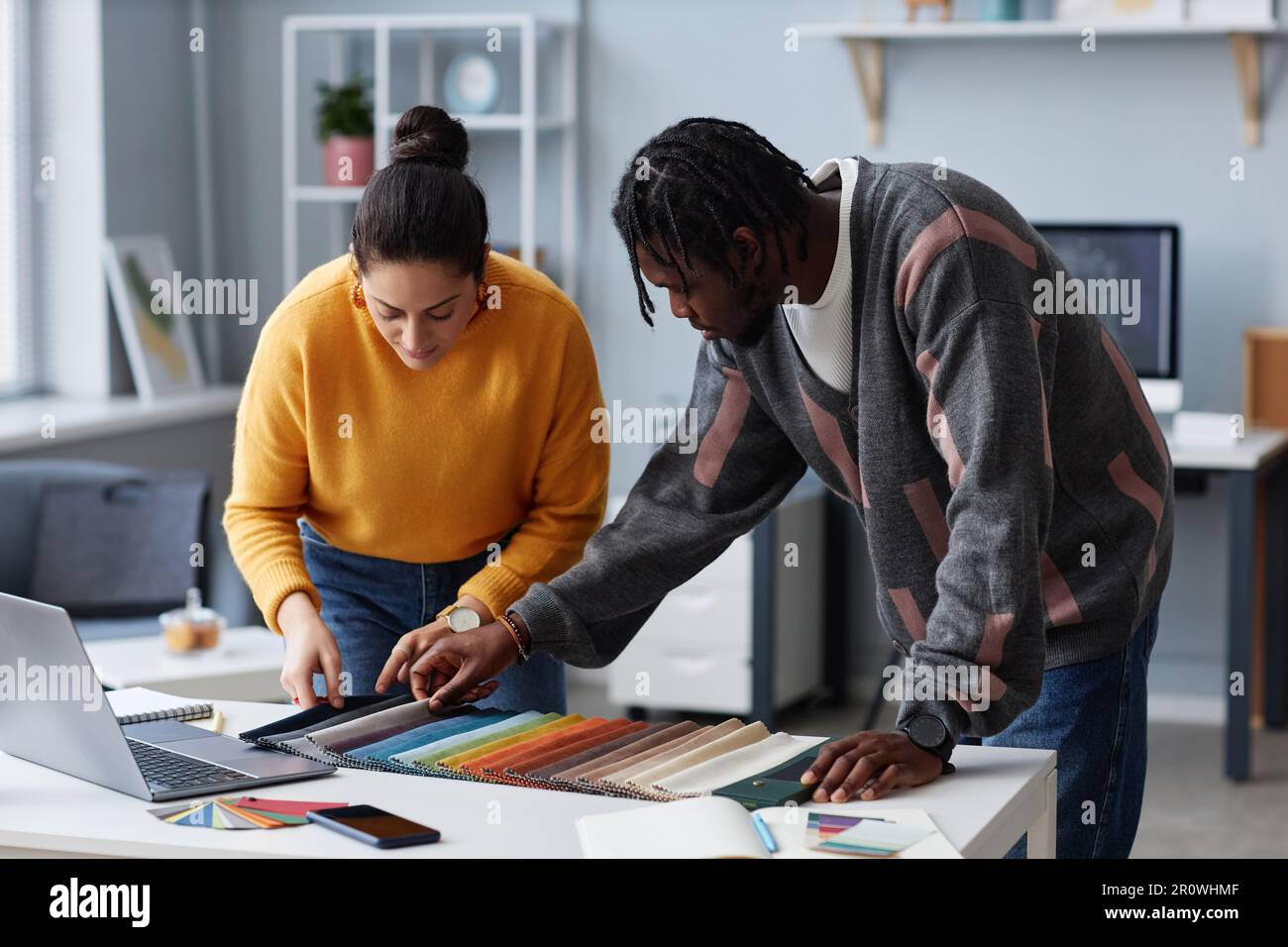 Couple of designers choosing color for interior on palette during their ...