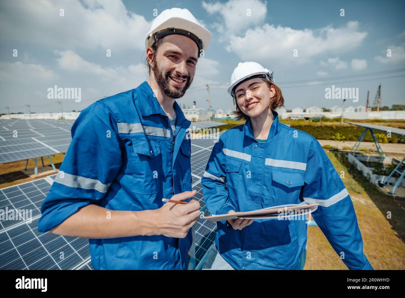 Solar engineers visually examine panel arrays on farm sites using ...