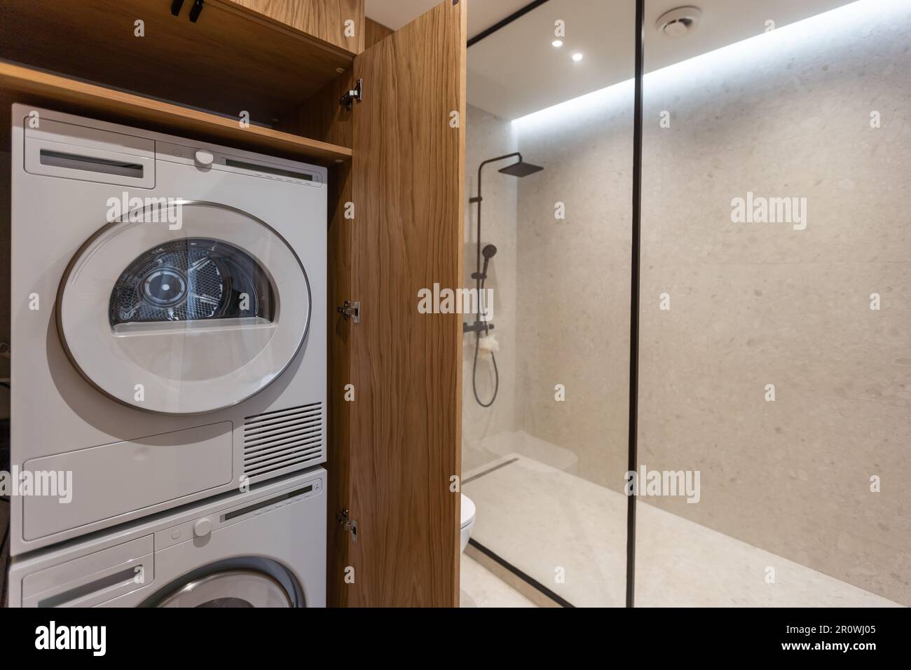 Marble laundry room interior with wooden countertops, a closet and ...