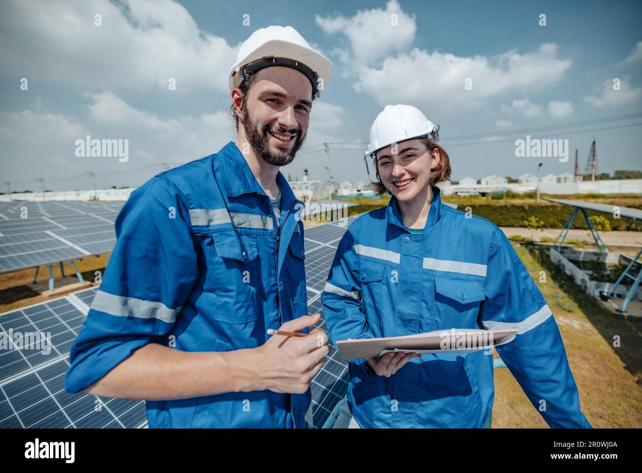 Solar engineers visually examine panel arrays on farm sites using ...