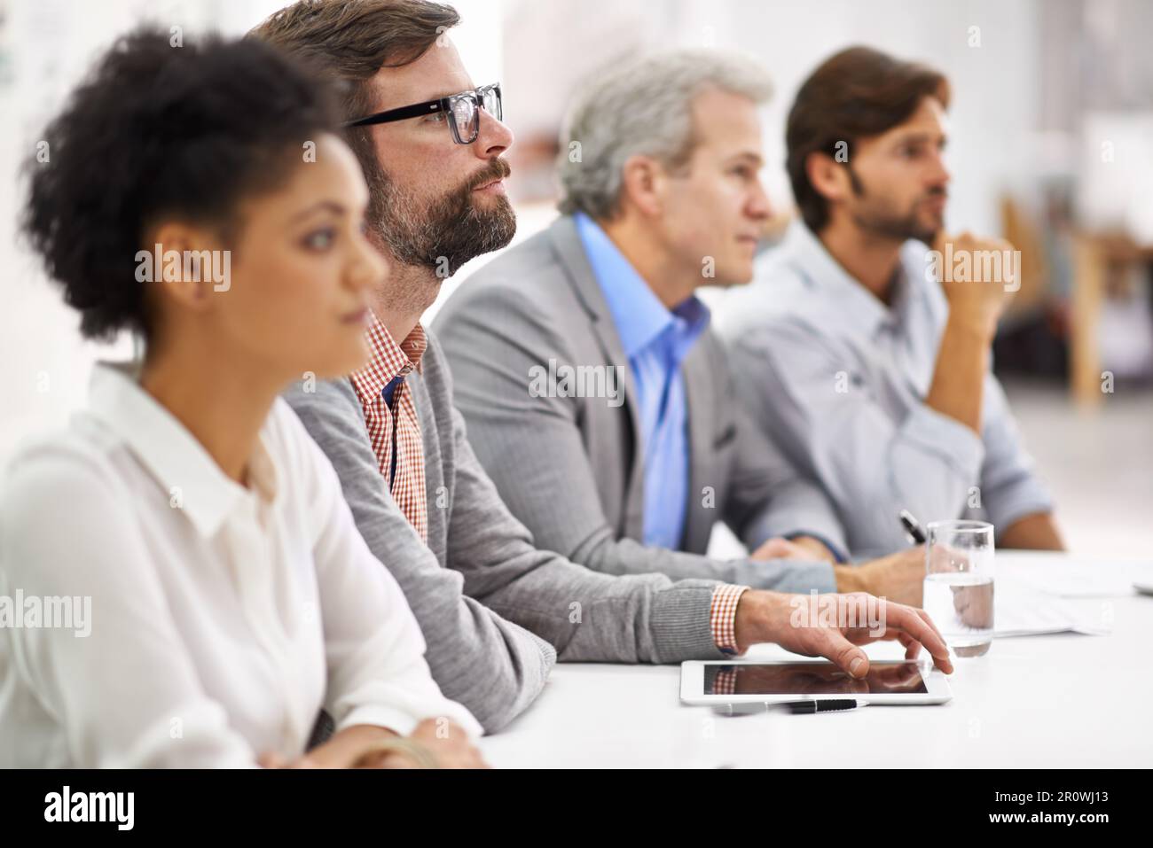 Project debriefing. a group of dedicated business professionals sitting ...