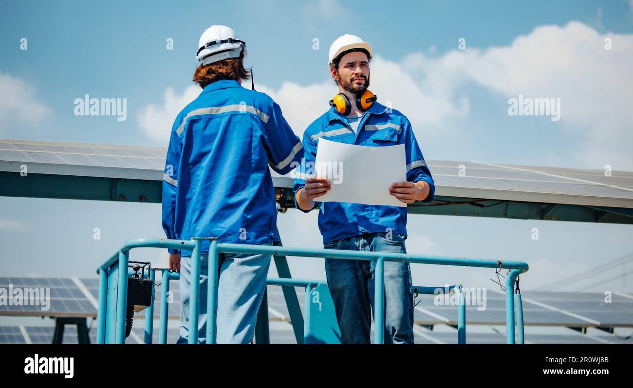 Solar engineers visually examine panel arrays on farm sites using ...