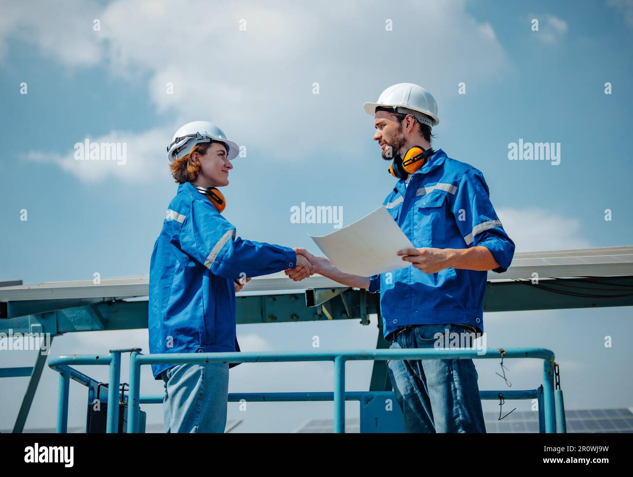 Solar engineers visually examine panel arrays on farm sites using ...