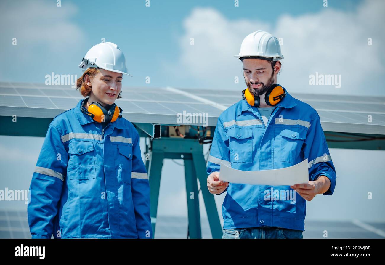 Solar engineers visually examine panel arrays on farm sites using ...