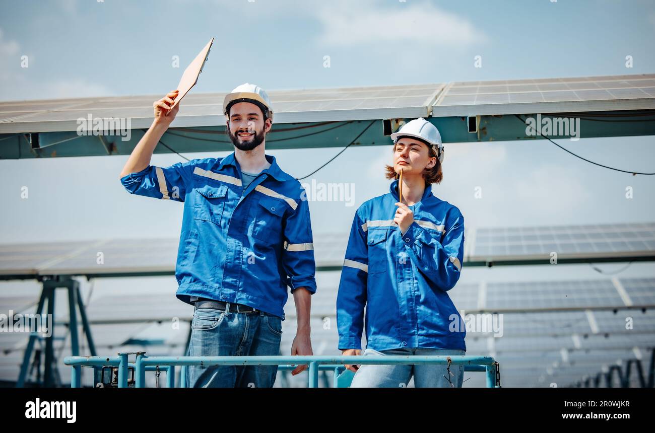 Solar engineers visually examine panel arrays on farm sites using ...