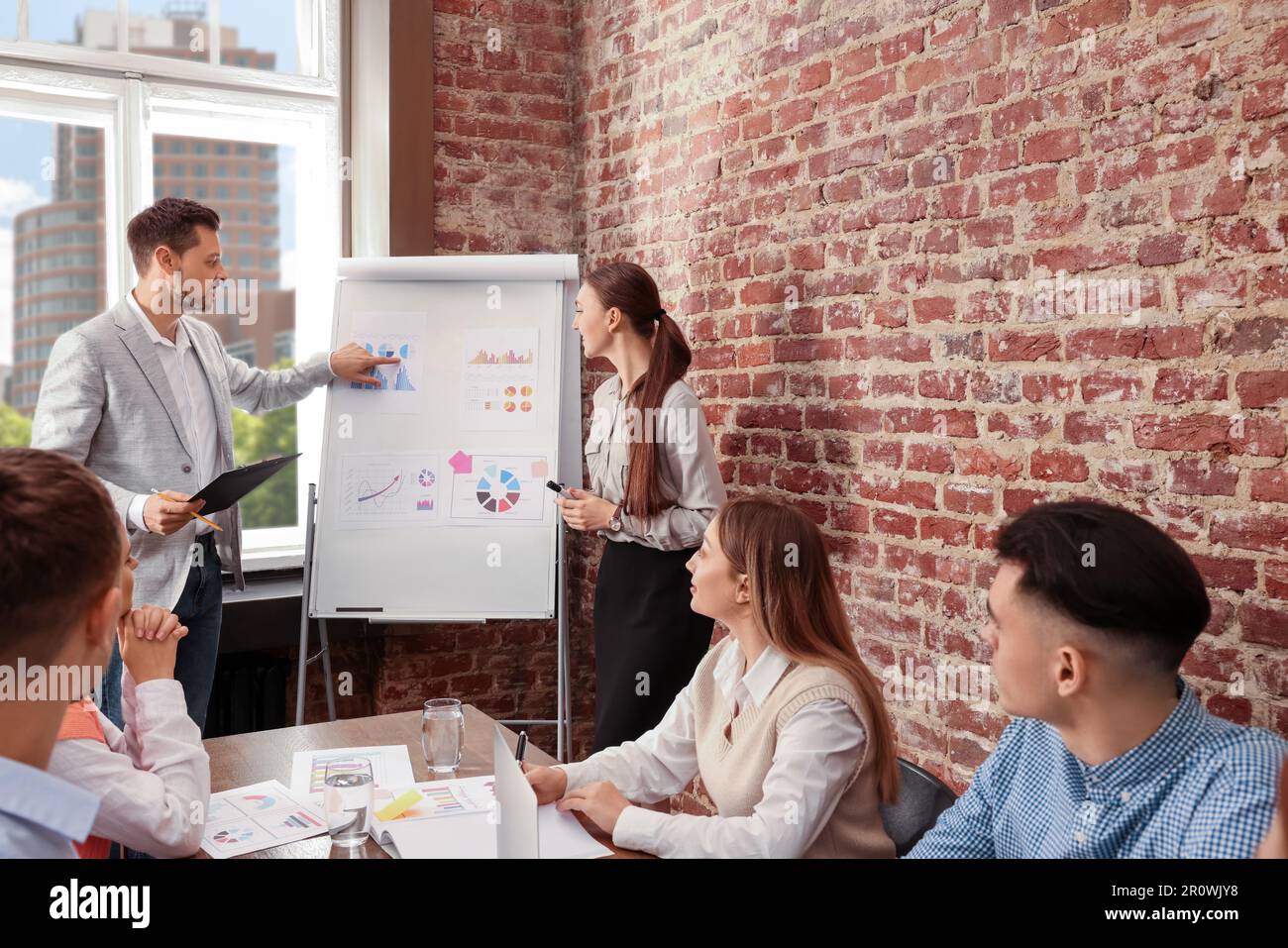 Employees having meeting in office. Team work Stock Photo - Alamy