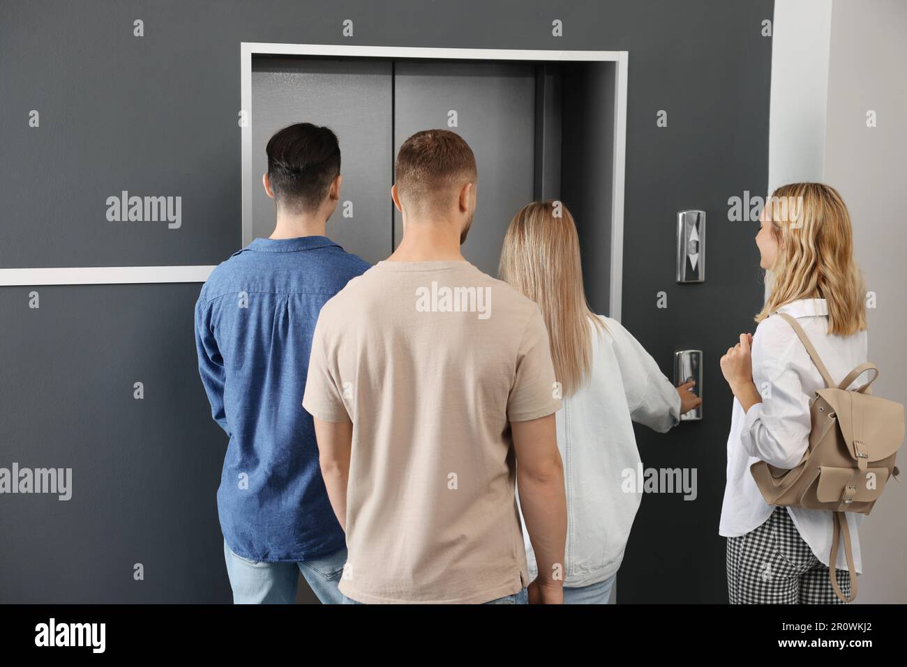 Group of people waiting for elevator in modern building Stock Photo - Alamy