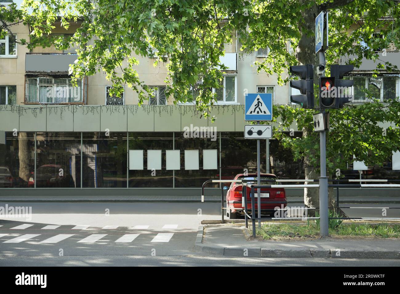 Building and different traffic signs near road on city street Stock ...