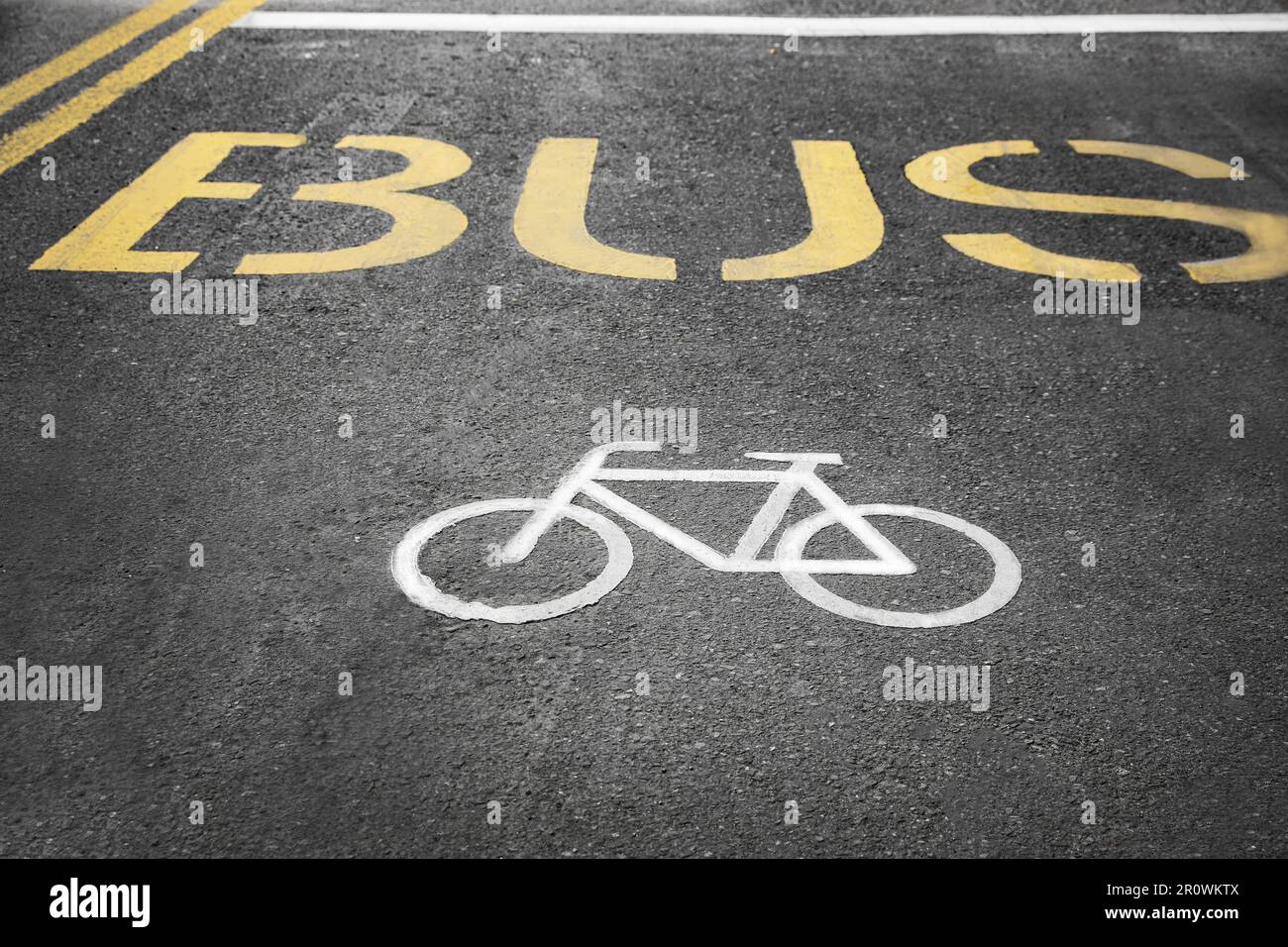 Bicycle and bus lane signs painted on asphalt Stock Photo - Alamy