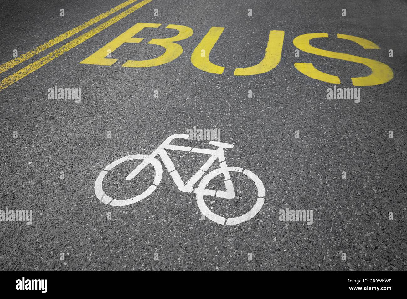 Bicycle and bus lane signs painted on asphalt Stock Photo - Alamy