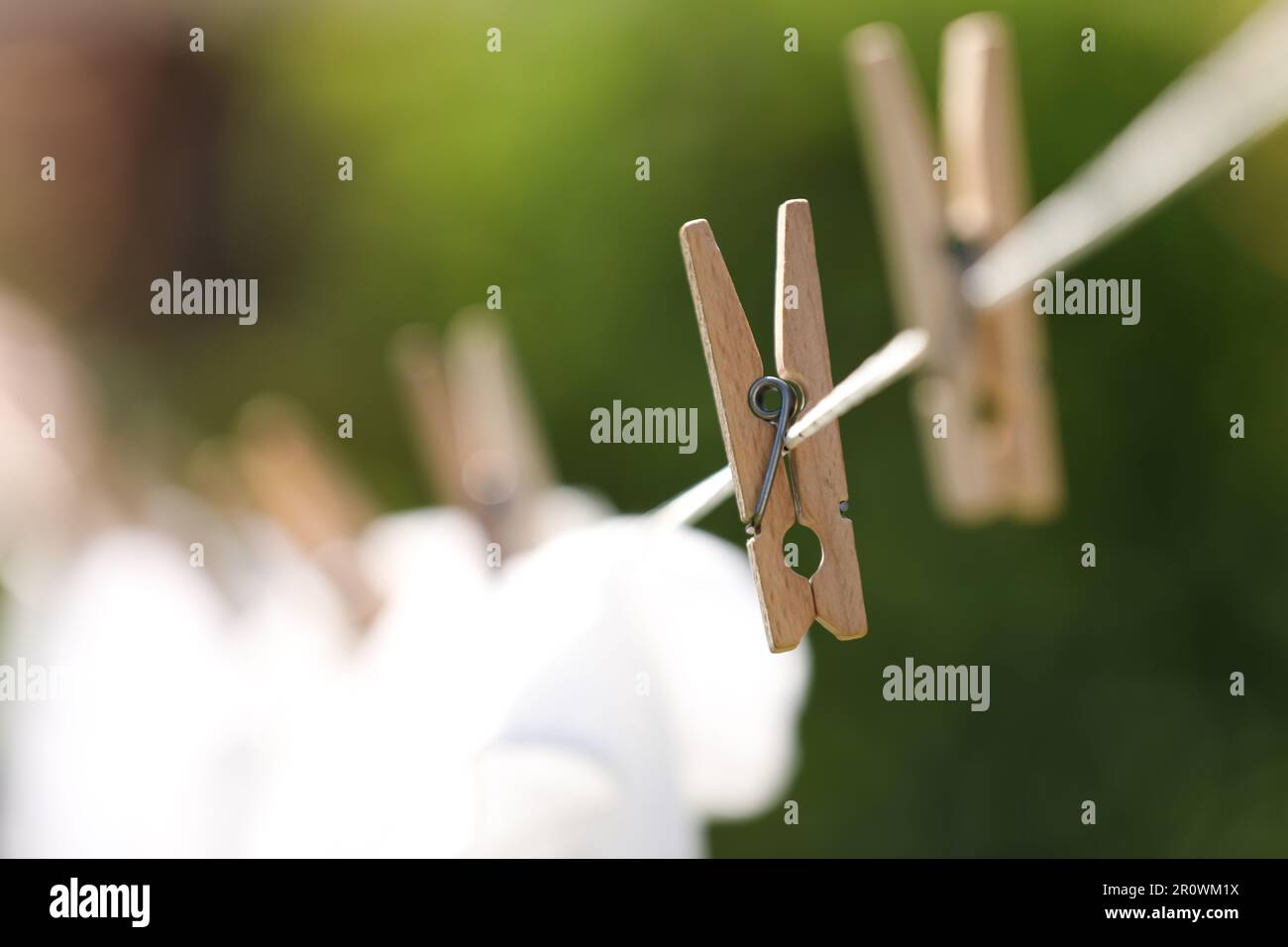Washing line with wooden clothespin outdoors, closeup. Drying clothes Stock Photo - Alamy