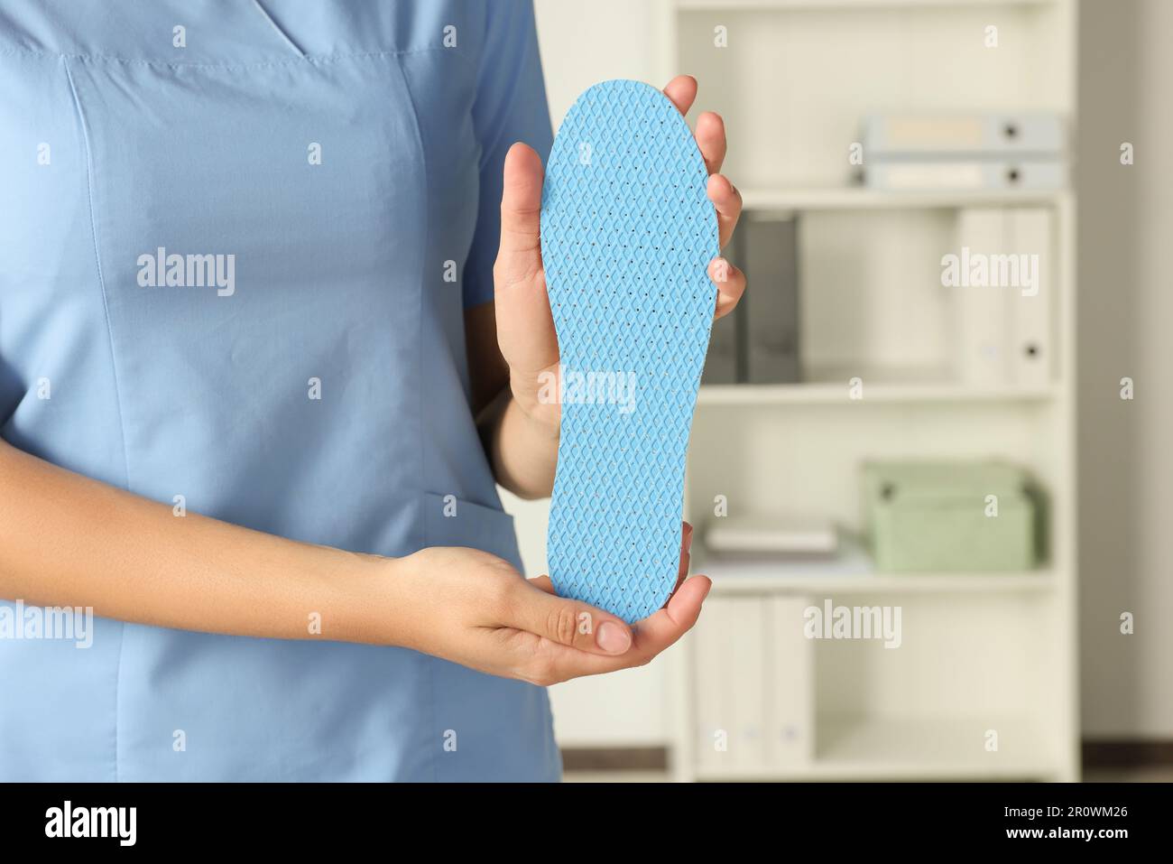 Female orthopedist showing insole in hospital, closeup Stock Photo - Alamy