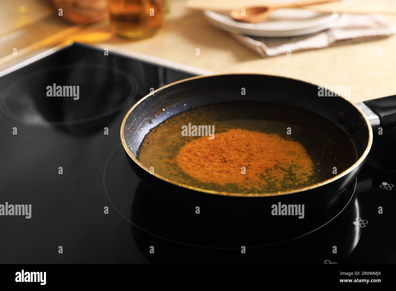 Frying pan with used cooking oil on stove Stock Photo - Alamy