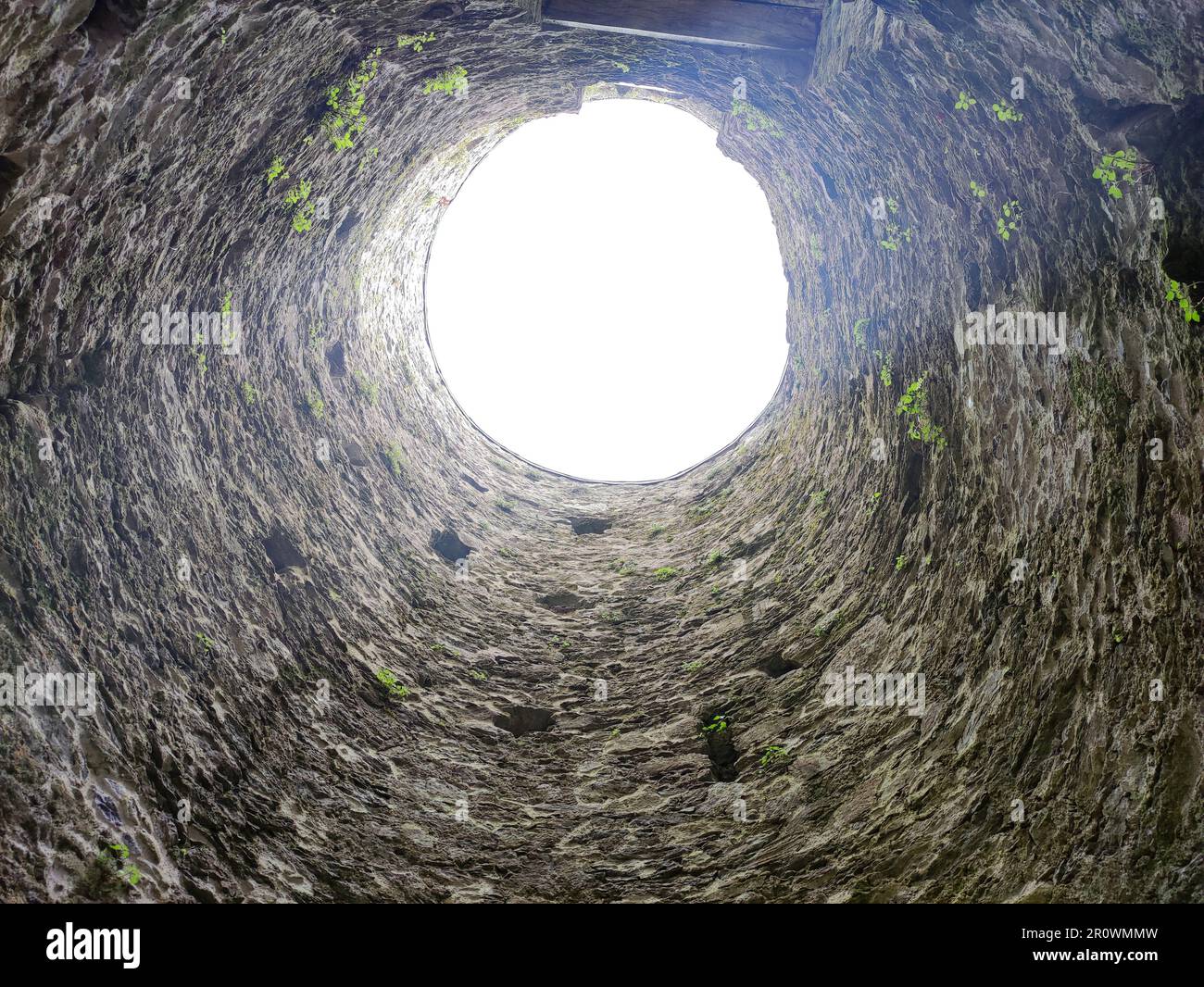 Stone well hole, old construction from inside, fall down in the well ...