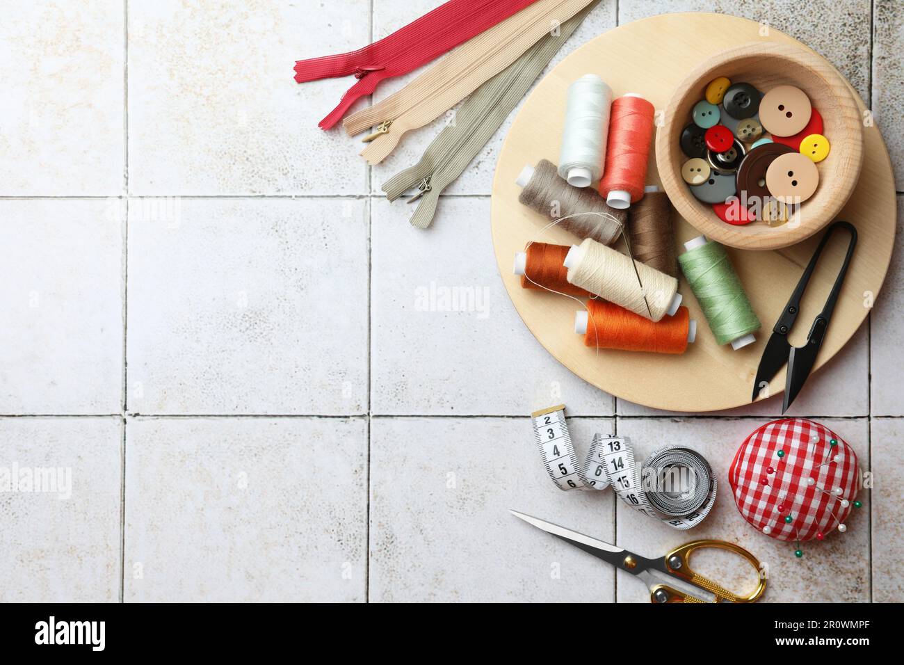 Flat lay composition with spools of threads and sewing tools on light ...