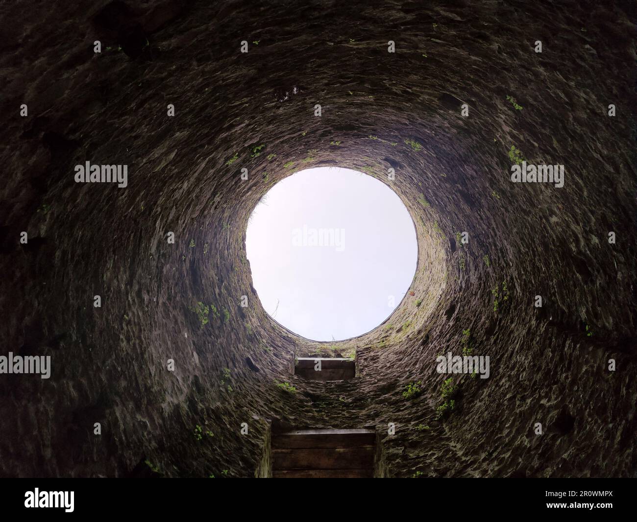 Stone well hole, old construction from inside, fall down in the well ...