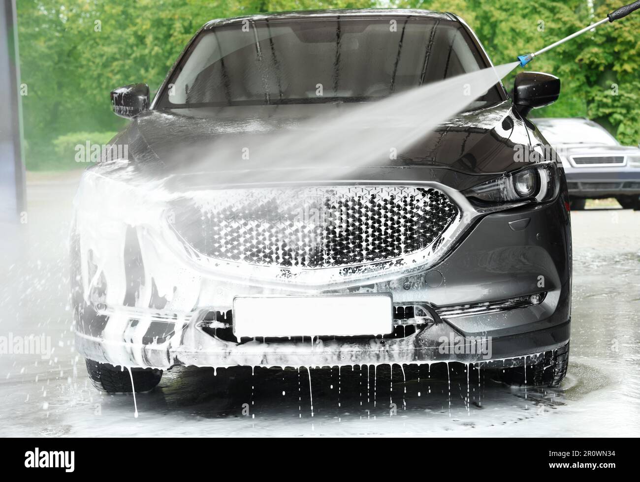 Washing auto with high pressure water jet at outdoor car wash Stock ...