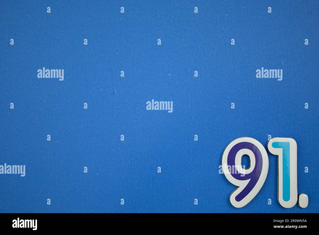 The number 91 in light blue color, photographed from above, placed on ...