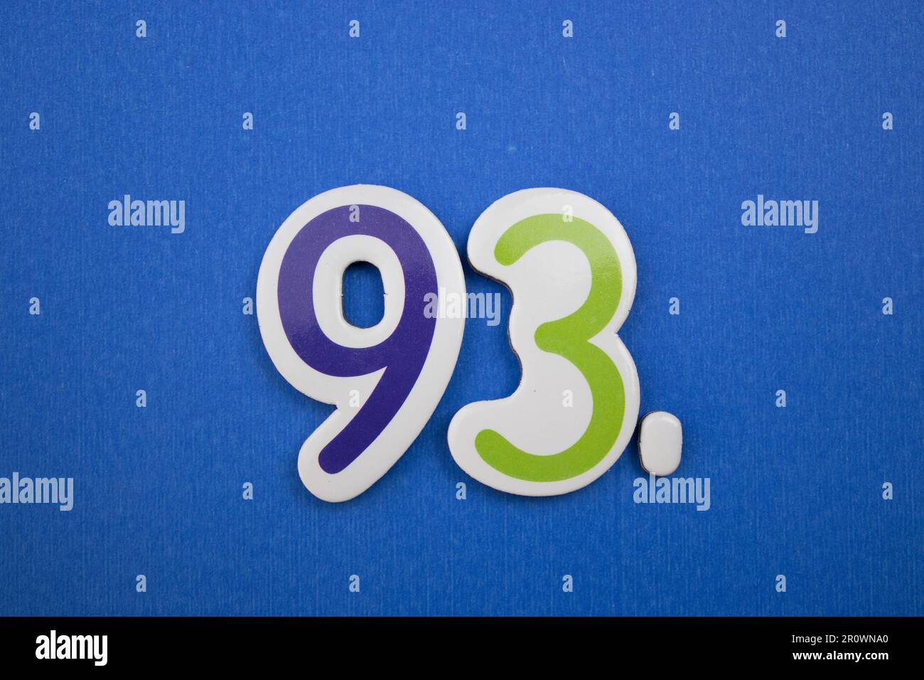 The number 93, placed on a blue background, photographed from above ...