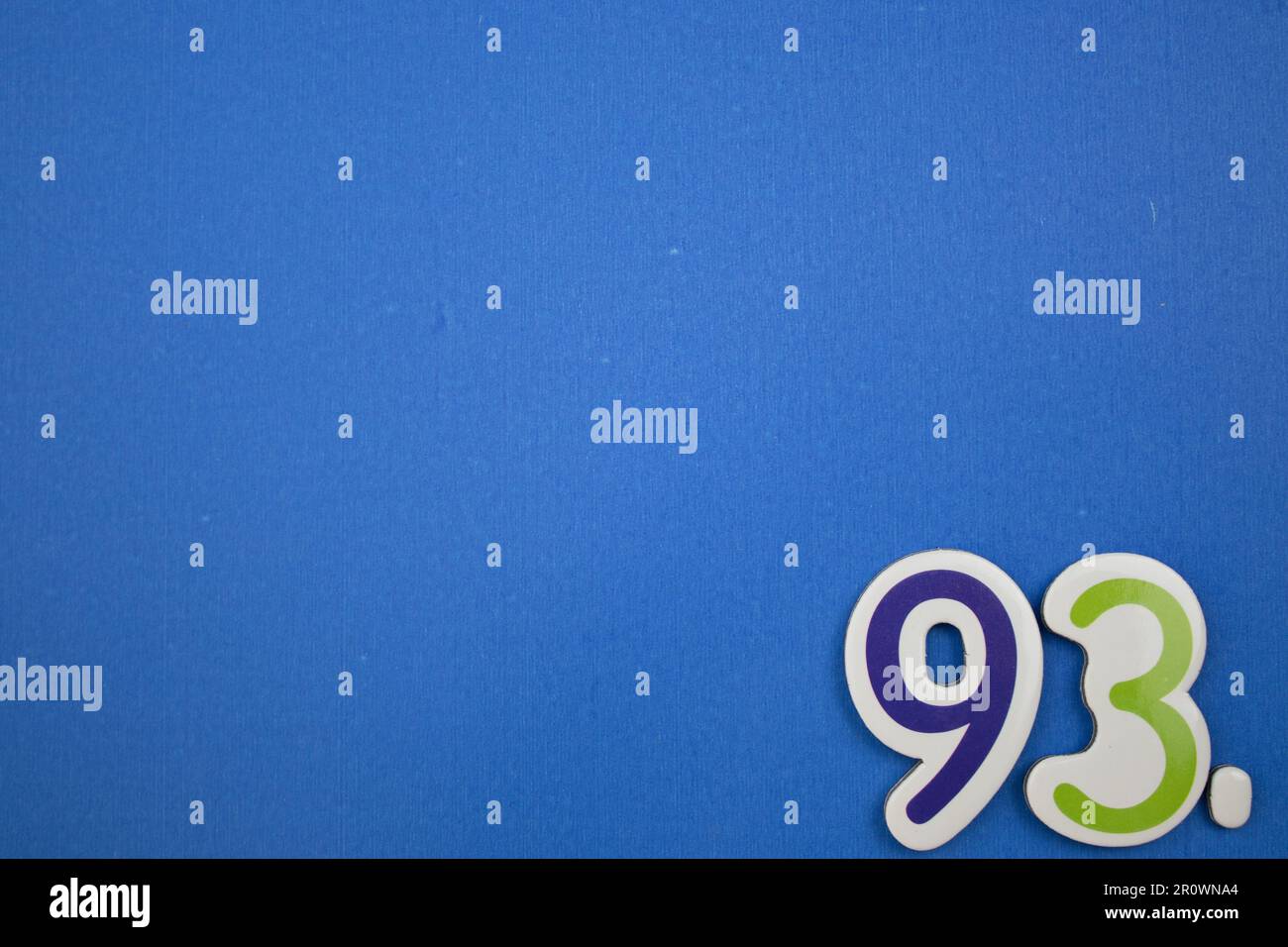 The number 93, placed on the edge of a blue background, photographed ...
