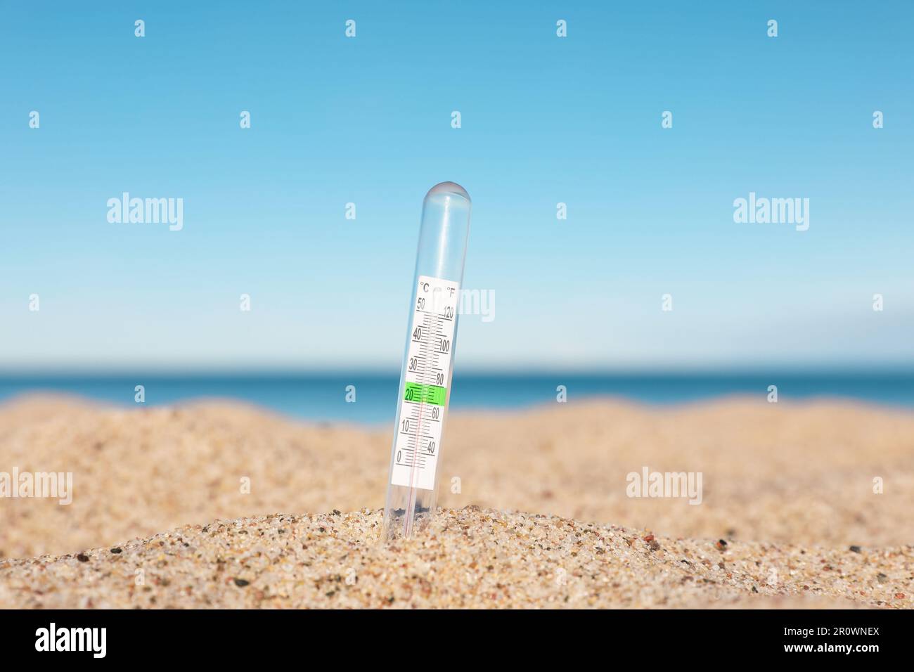 Glass weather thermometer in sand near sea Stock Photo - Alamy