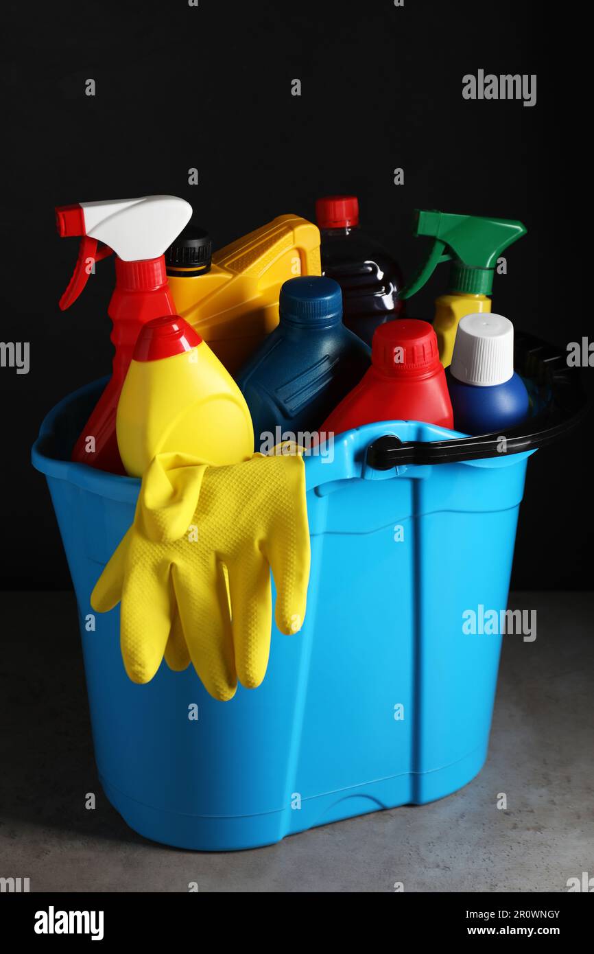 Light blue bucket with car cleaning products on grey table Stock Photo ...