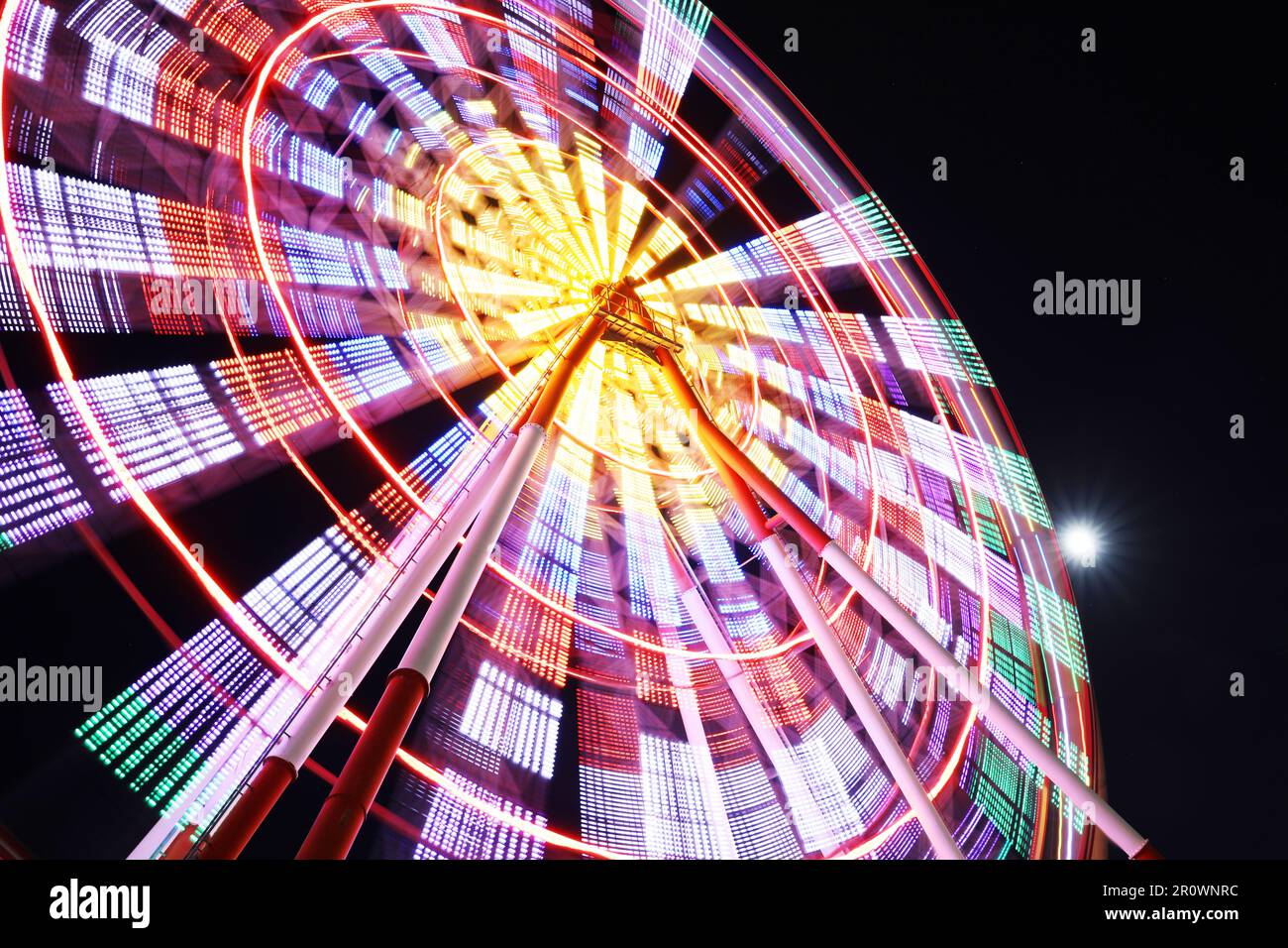 Beautiful glowing Ferris wheel against dark sky, low angle view Stock ...