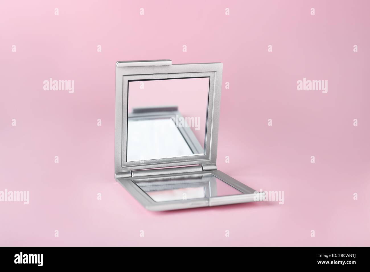 Stylish cosmetic pocket mirror on pink background Stock Photo - Alamy