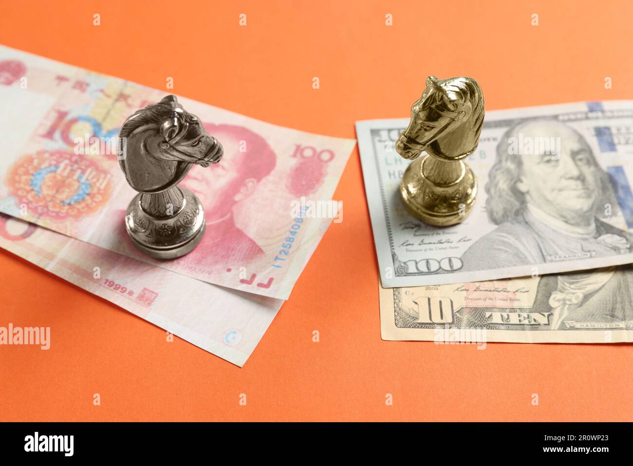 Chess pieces and money on orange background. China–United States trade ...