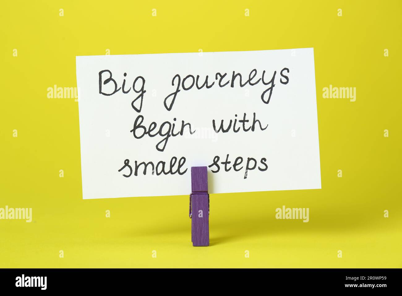 Card with phrase Big Journeys Begin With Small Steps and clothespin on ...