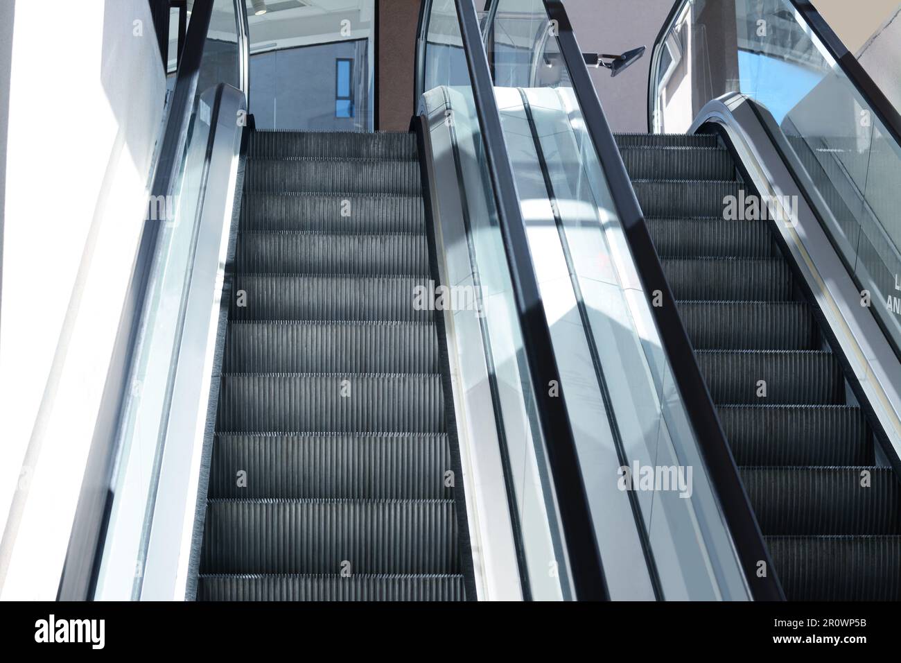 Modern escalators with handrails in shopping mall Stock Photo - Alamy