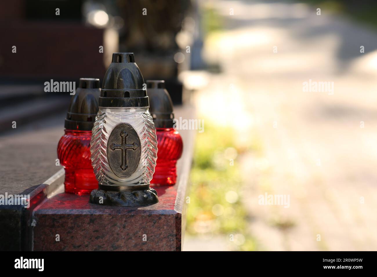 Grave lanterns on granite surface in cemetery, space for text Stock Photo - Alamy