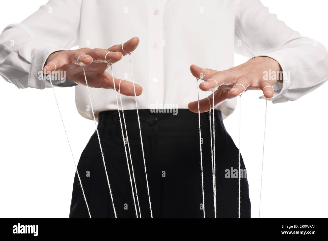 Woman in formal outfit pulling strings of puppet on white background ...