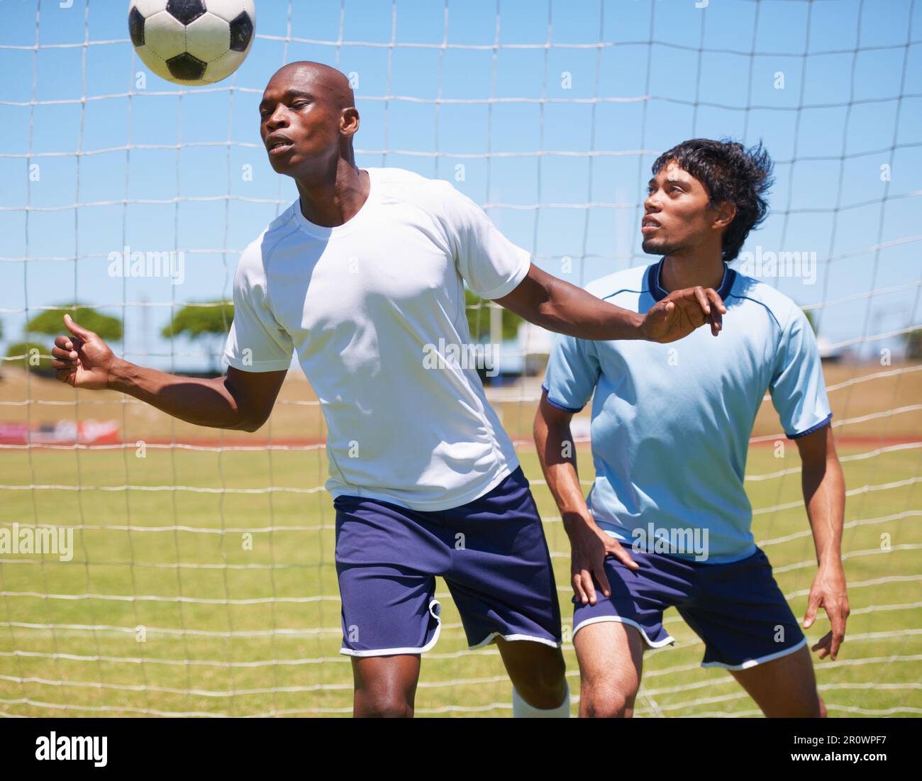 Men, sport and soccer with header, ball and contest for defender and ...