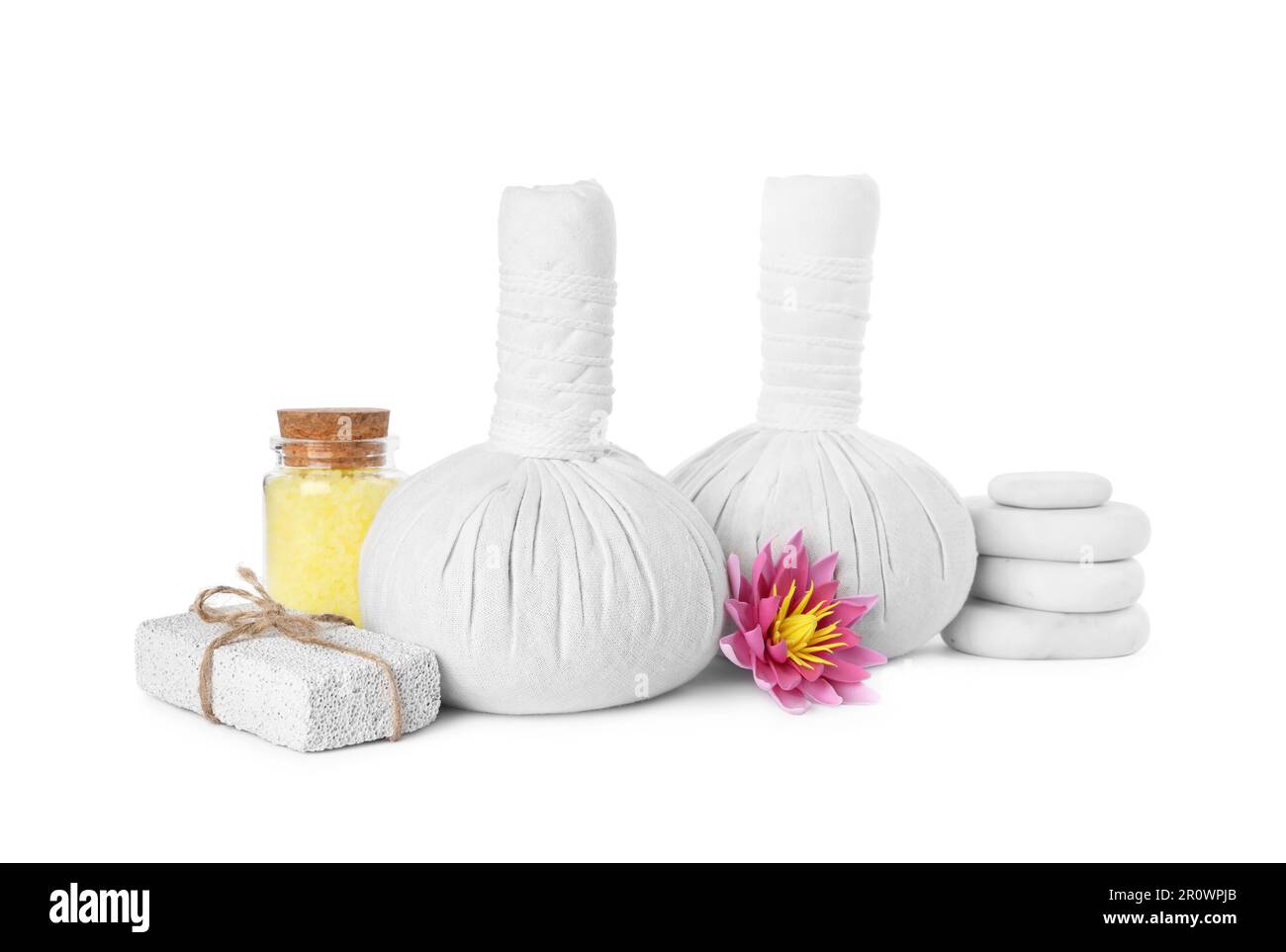 Herbal massage bags and different spa products on white background ...