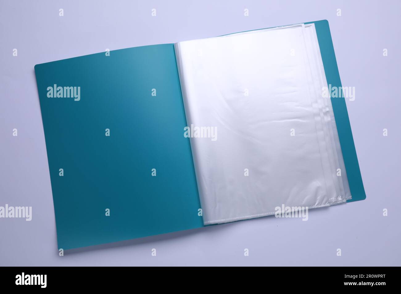 File folder with punched pockets and paper sheets isolated on white ...